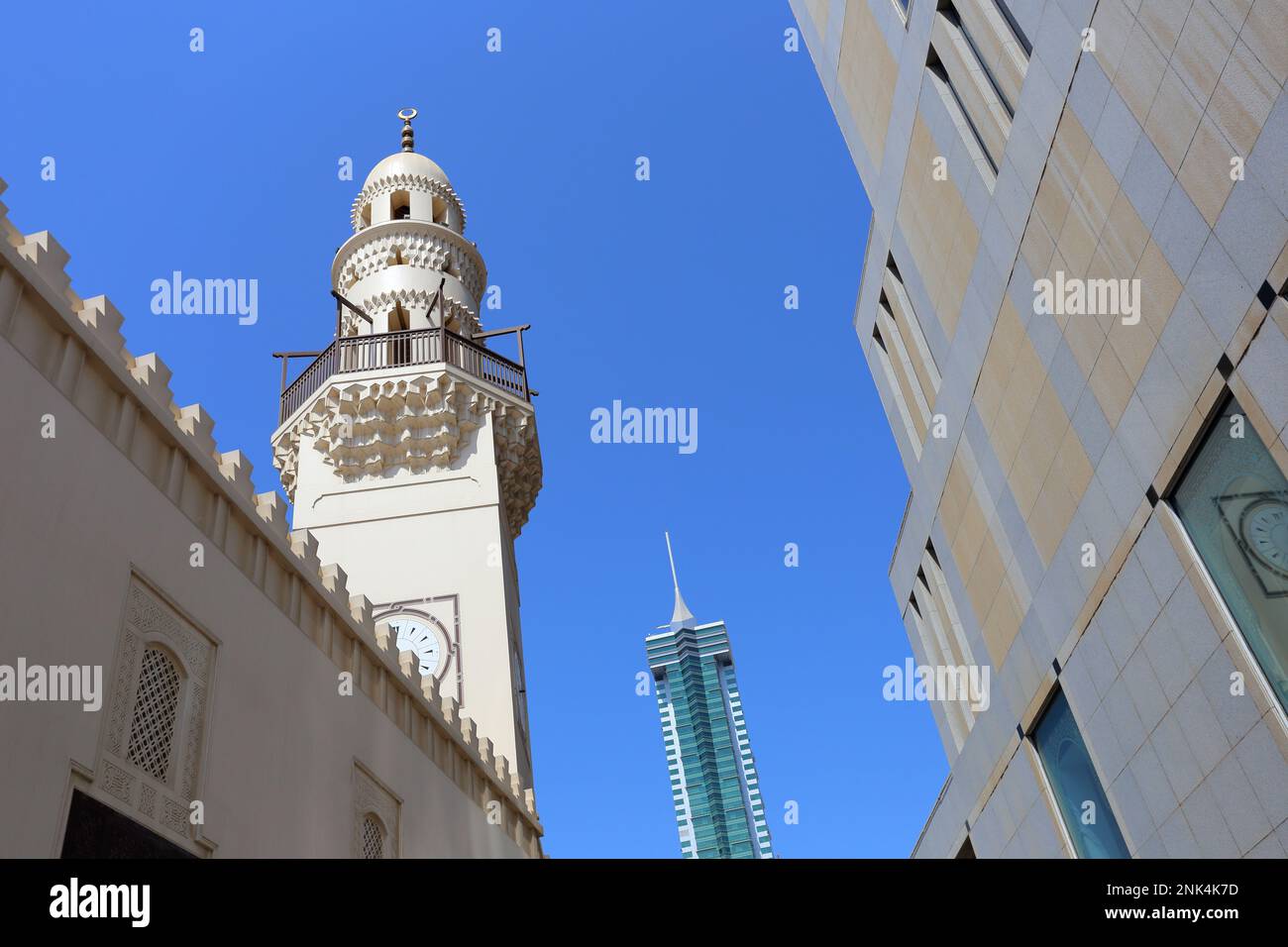 Al Yateem Mosque and the Batelco building with one of the towers of the ...