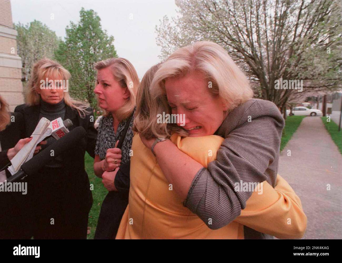 Krissy Ambrusko, right, a sister of Sara Tokars, gets a hug from a ...