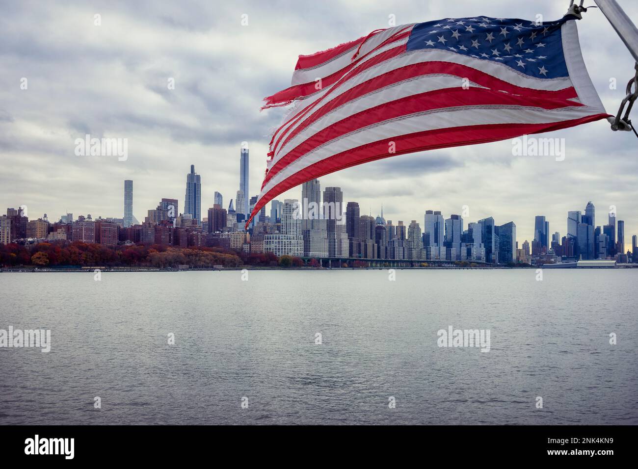 American flag and scenic view of the New York Manhattan skyline as seen ...