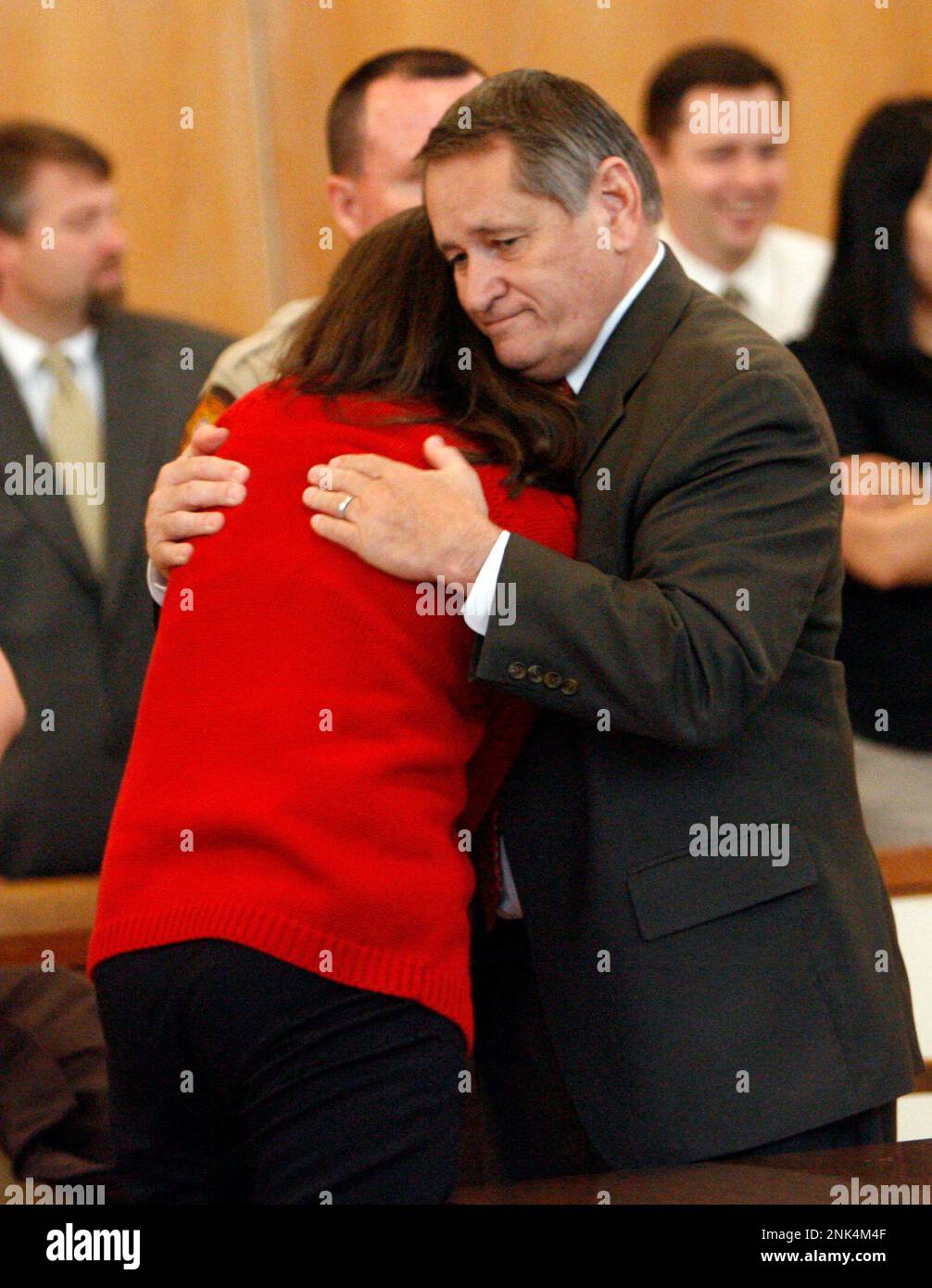 Lynn Turner, back to camera, gets a goodbye hug from defense lawyer ...