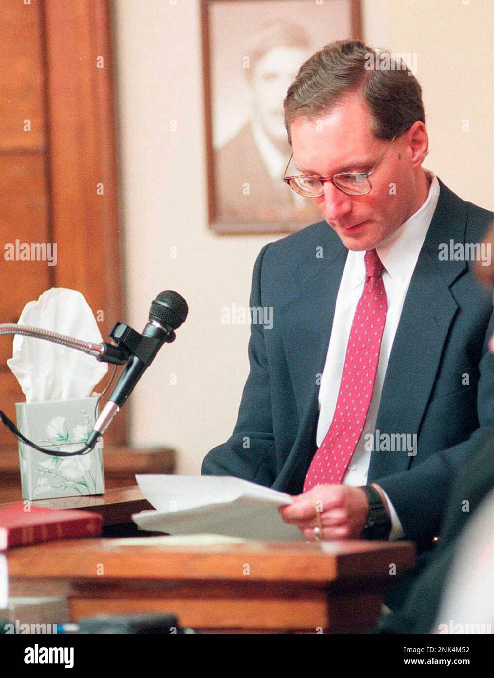 Andy Tokars, younger brother of murder defendant Fred Tokars, reads the ...