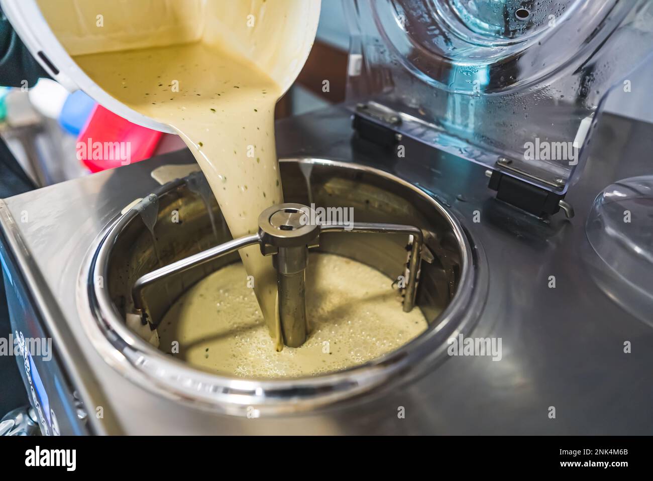 Pouring ice cream mix into a pasteurizing machine. High quality photo ...