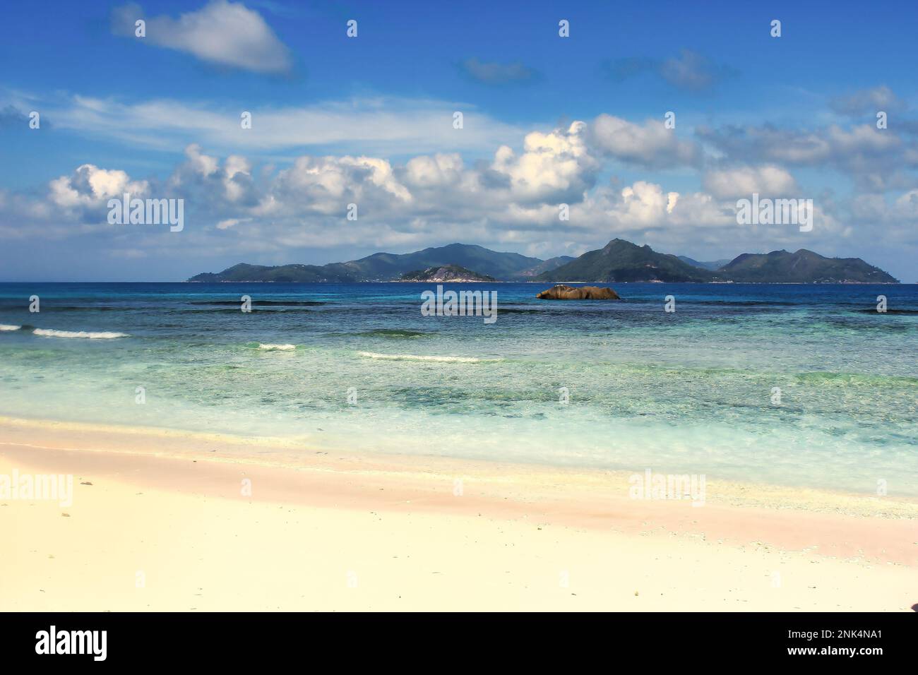 The blue waters off the Anse Reunion beaches on La Digue Island ...