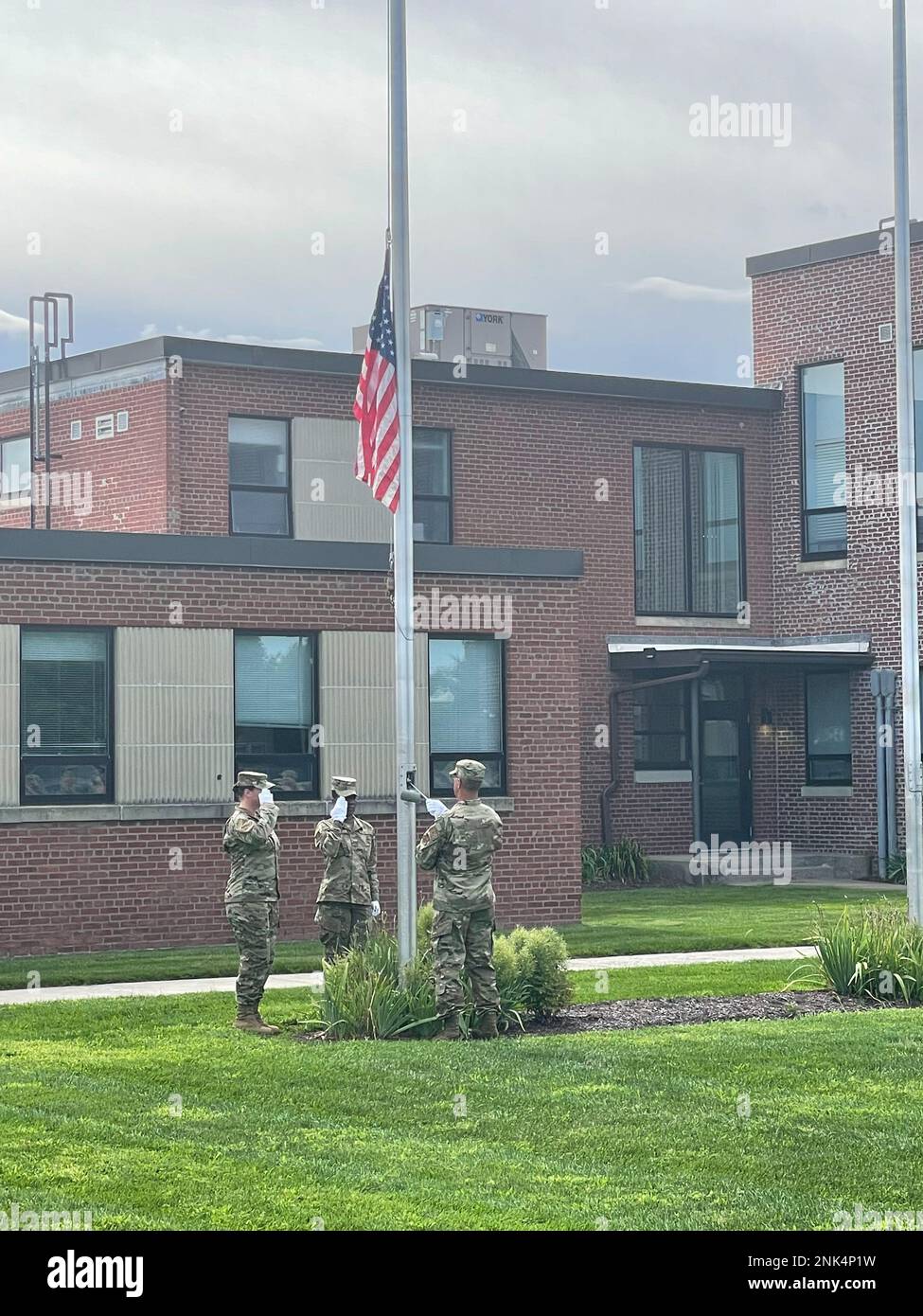 United States Air Force 104th Fighter Wing Airmen raise the flag during ...
