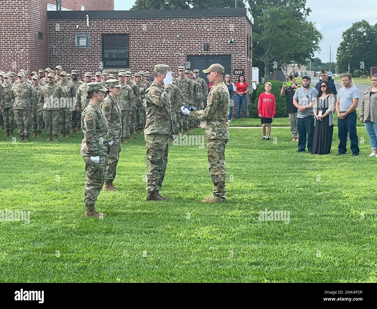A 104th Fighter Wing flag detail salutes the flag during a ceremony for ...