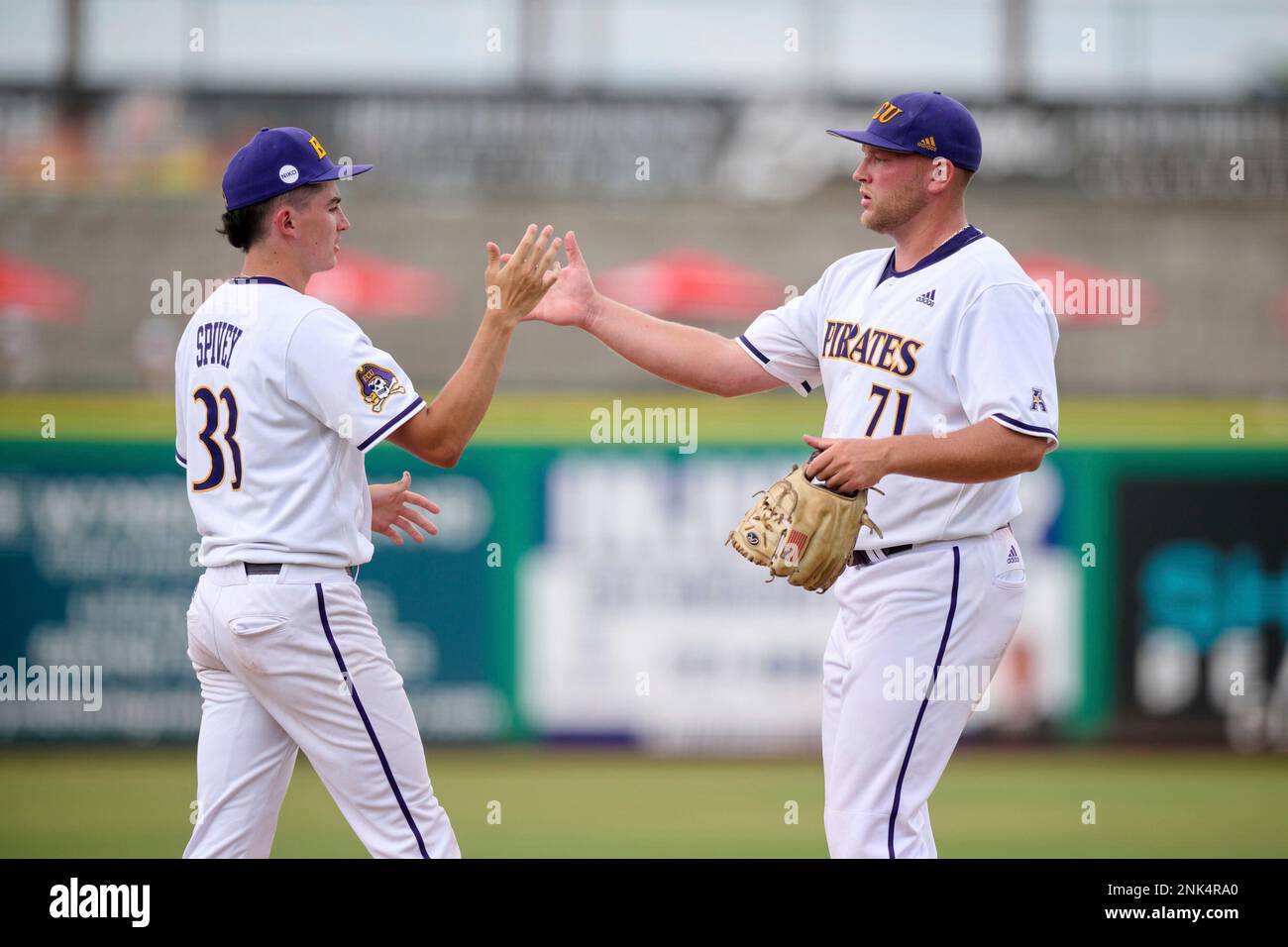 ECU Pirates pitcher Ben Terwilliger (71) high fives Carter Spivey (33 ...