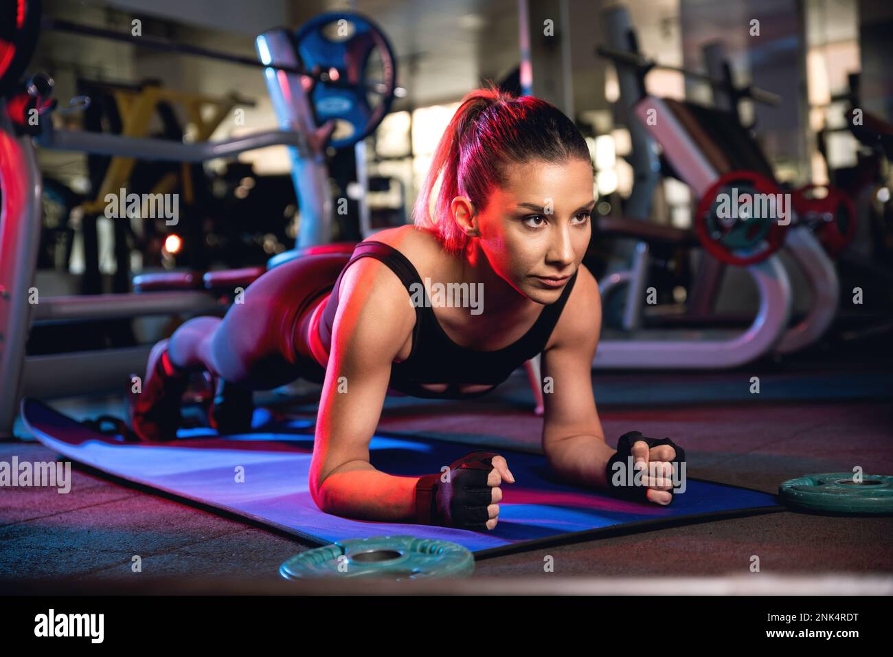 One 30s woman doing a plank exercise in a gym Stock Photo - Alamy