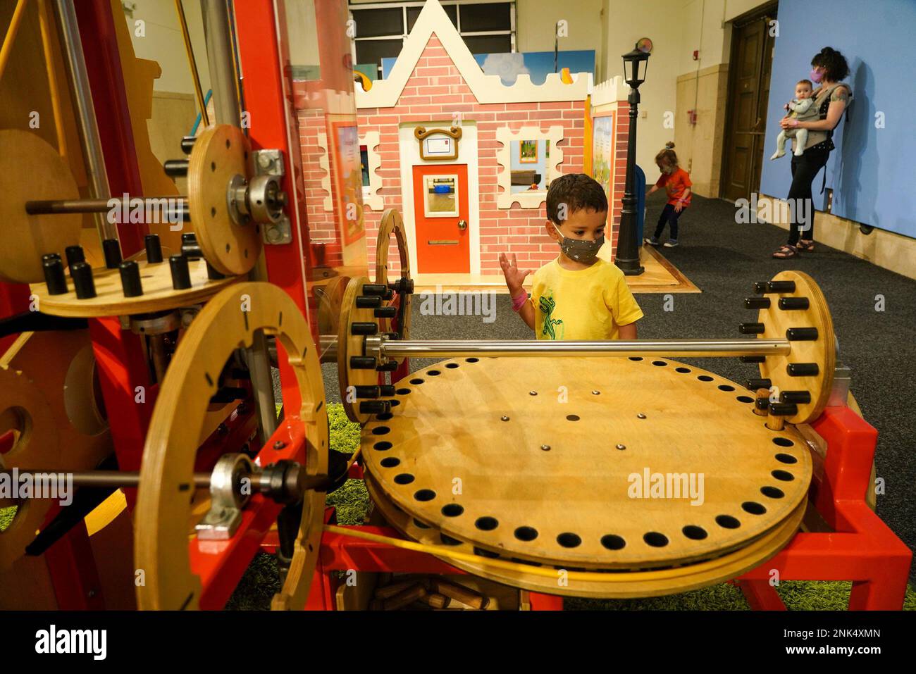 Kieran Glover, 3, checks out the gears of a big clock at the Clock ...