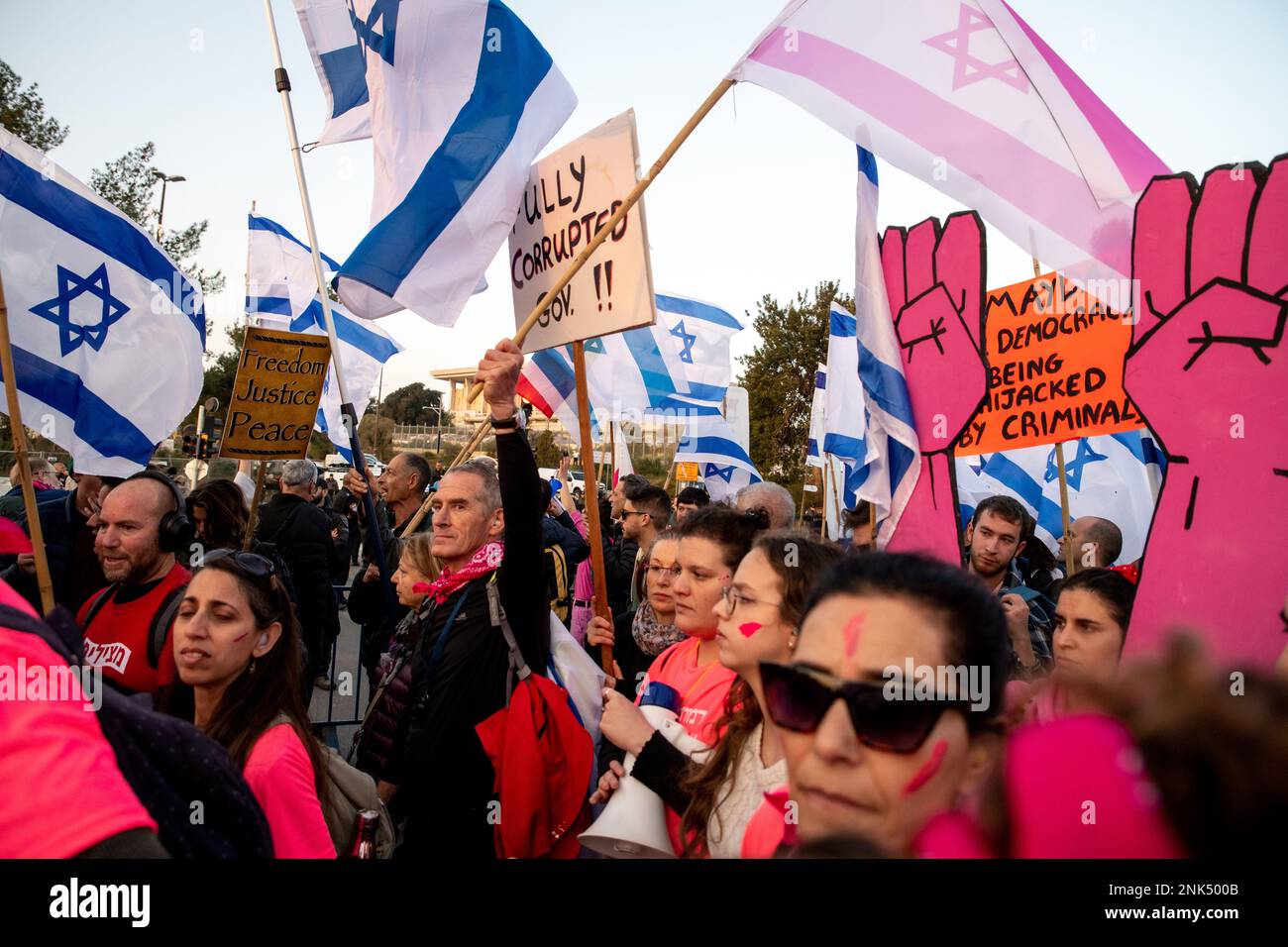 Israel. 20th Feb, 2023. Israeli protestors wave their flags and signs ...