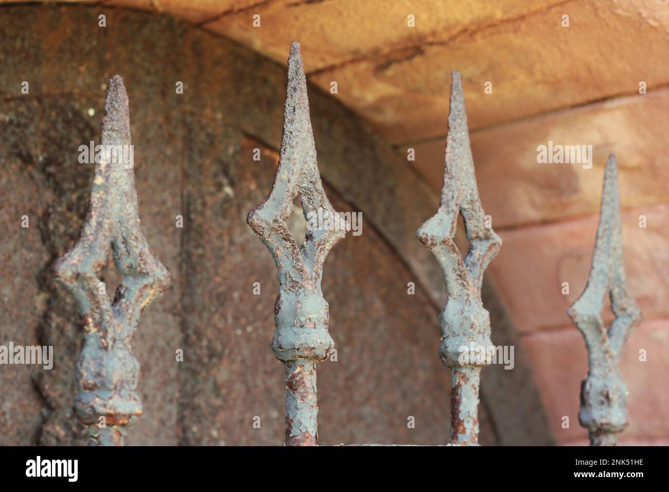Vintage traditional rusty metal fence with sharp points as a protection ...
