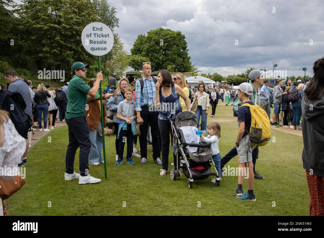Man holds sign 'End of Ticket Resale Queue' within the grounds of ...