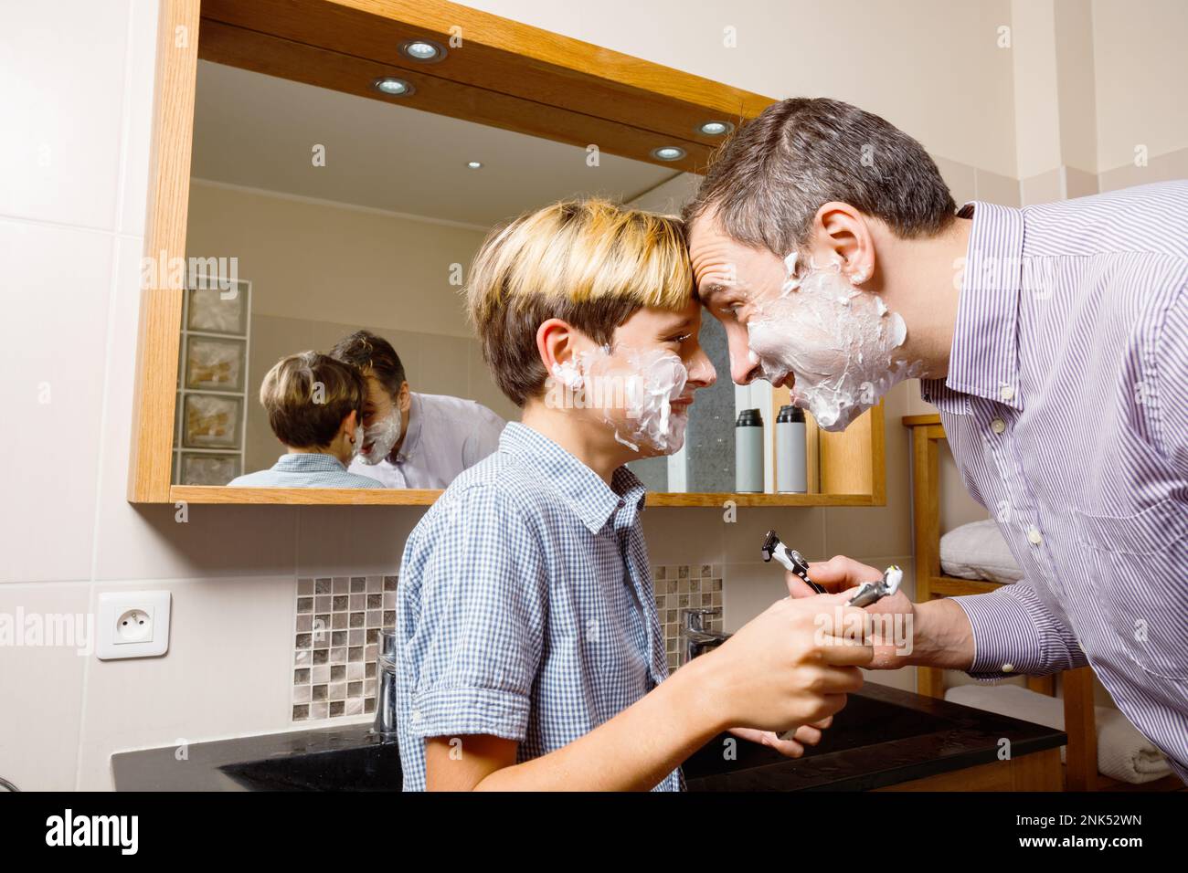 Dad and kid smiling during shaving touch foreheads hold razors Stock ...
