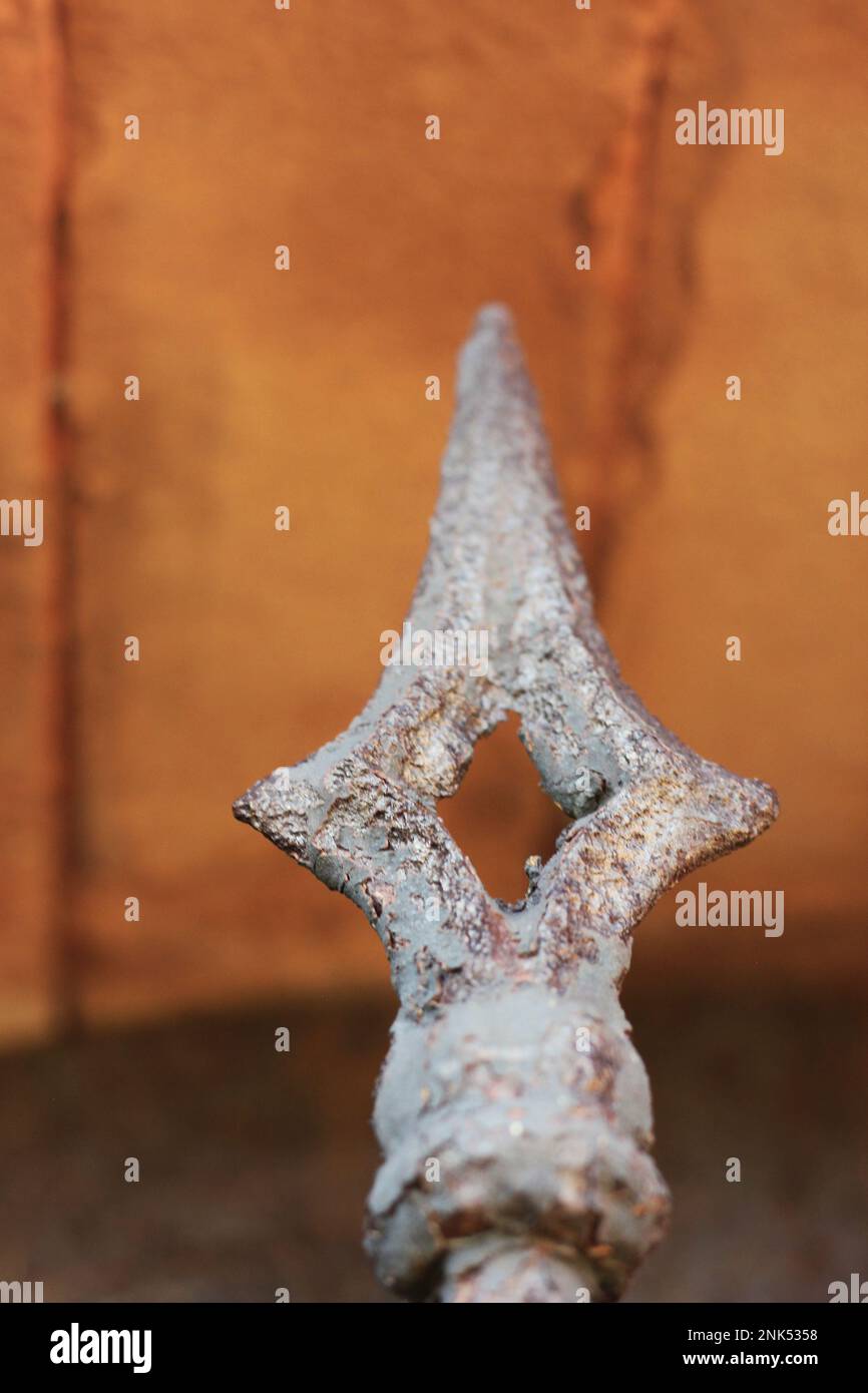 Vintage traditional rusty metal fence with sharp points as a protection ...