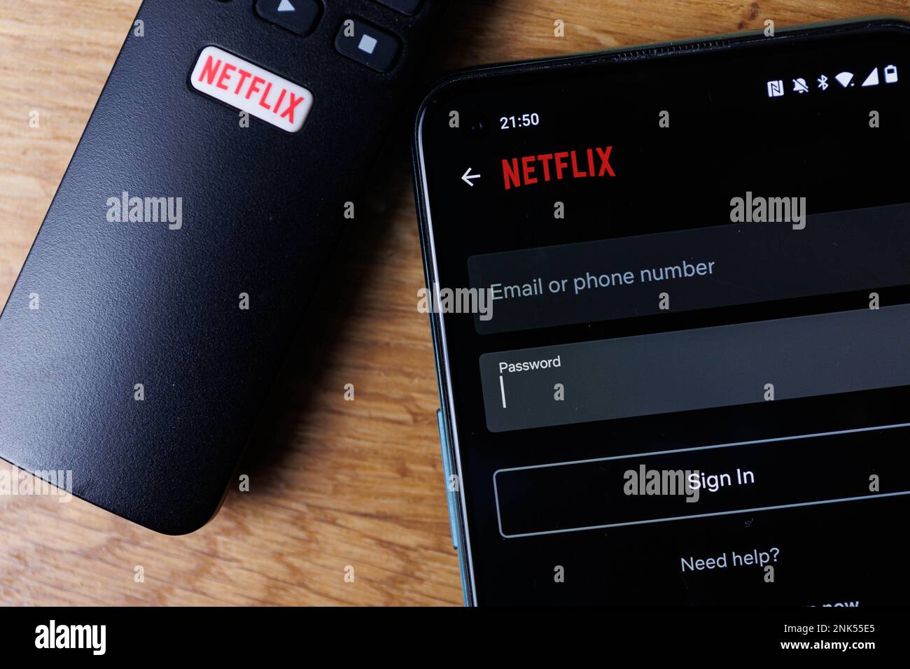 Netflix login on smartphone display. New password sharing rules on ...