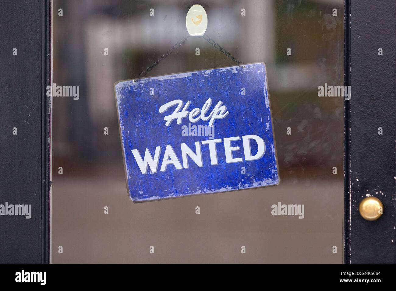 Closed-up on a blue sign with written in it: Help wanted Stock Photo ...