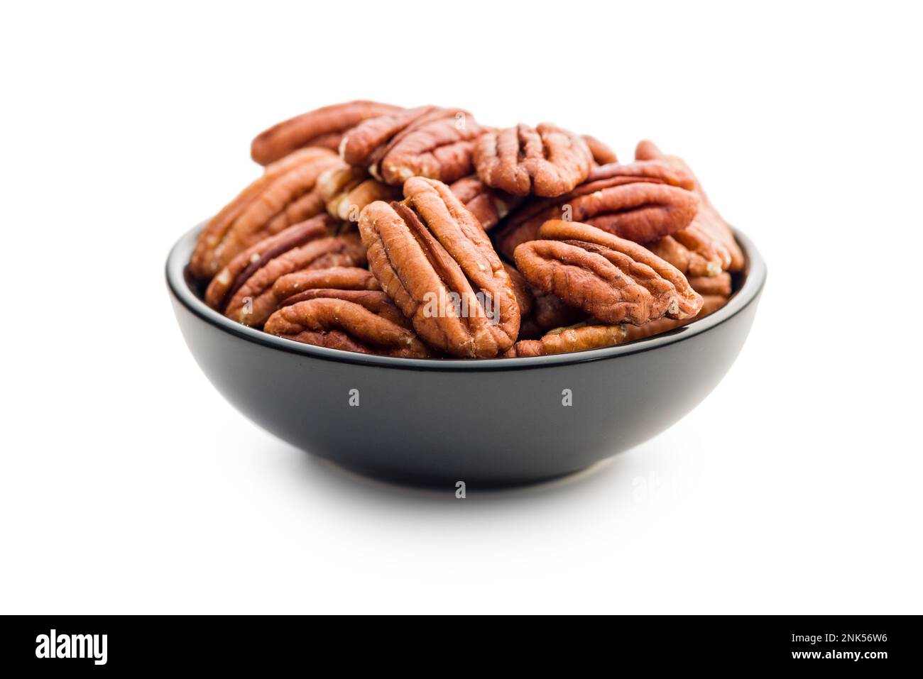 Peeled pecan nuts in bowl isolated on the white background Stock Photo ...