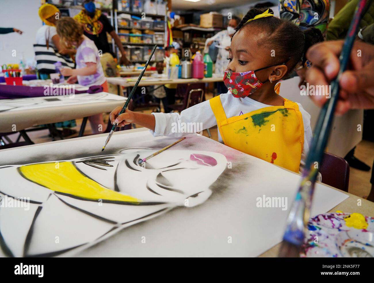 Nia Lewis, 4, of Homewood in Pittsburgh, paints an image of an African ...