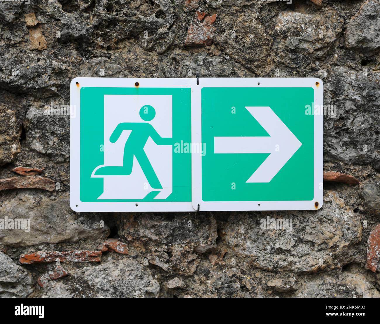 green emergency exit sign with the pictogram drawn with a stick figure ...