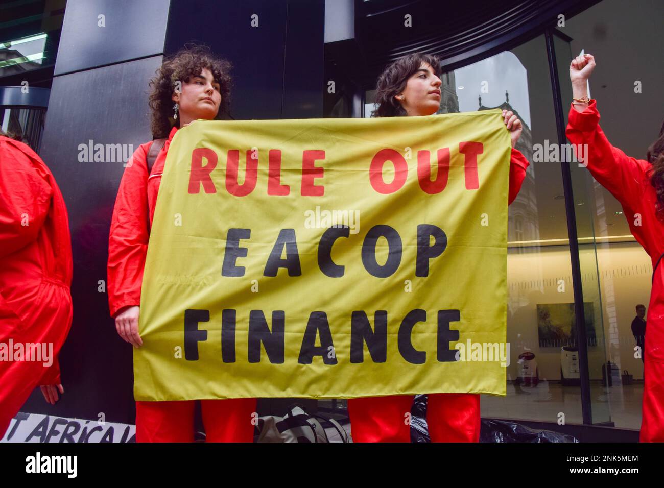 London, UK. 23rd Feb, 2023. Protesters hold an anti-EACOP banner during ...