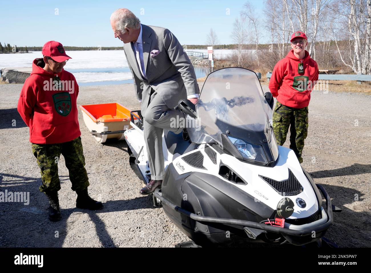 Prince Charles, center, dismounts a snowmobile during a review of the ...