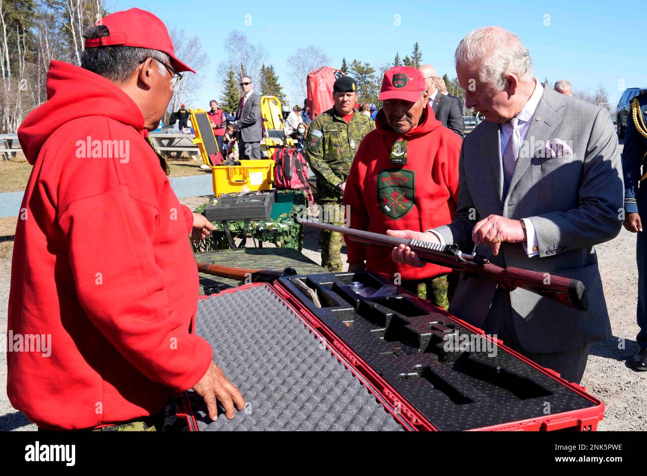 Prince Charles, center, is shown the operation of a snowmobile during a ...