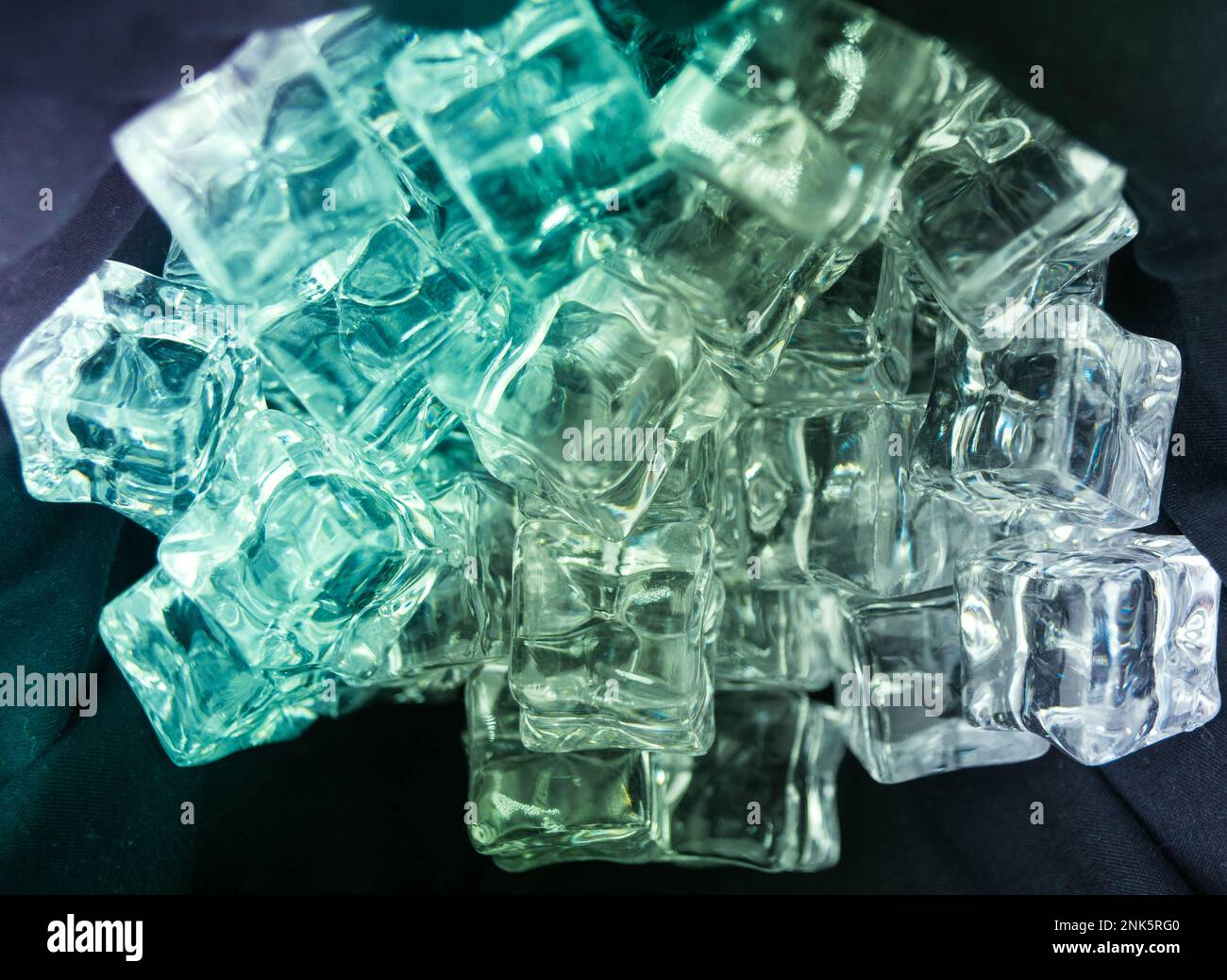 diffuse light shines on a handful of ice cubes Stock Photo - Alamy