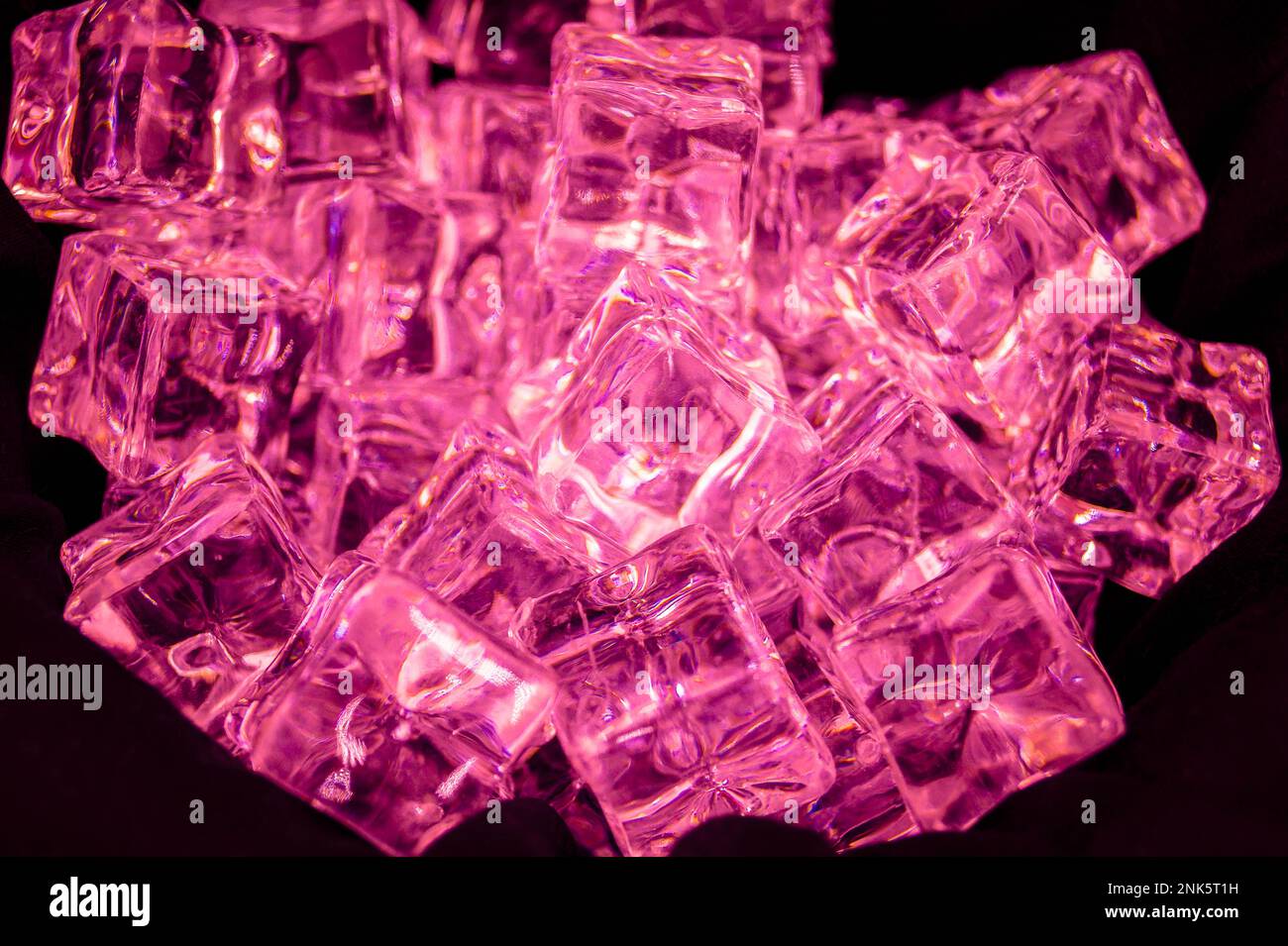 diffuse light shines on a handful of ice cubes Stock Photo - Alamy
