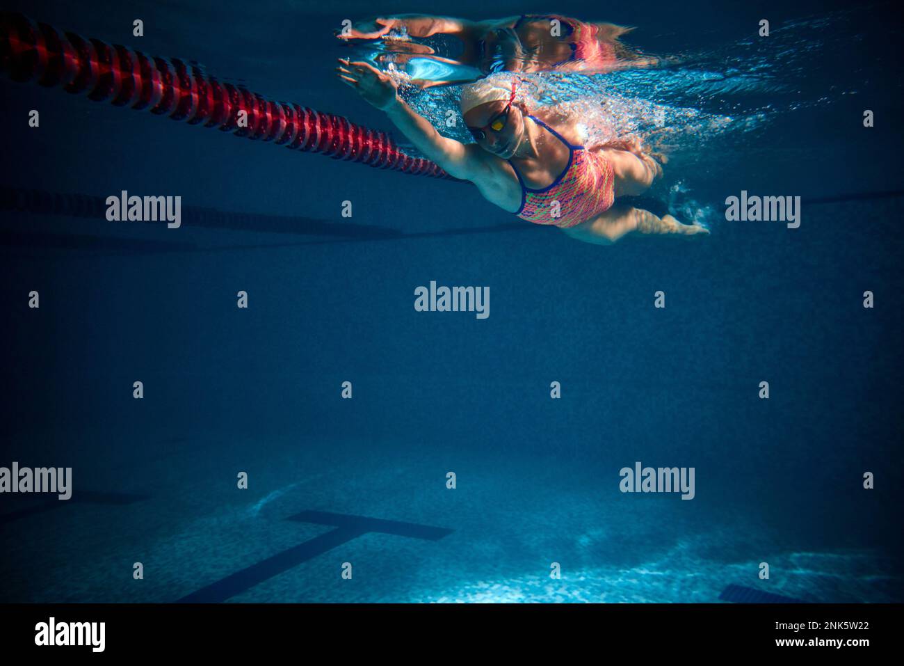 Front crawl. Young woman, professional swimmer in goggles and cap ...