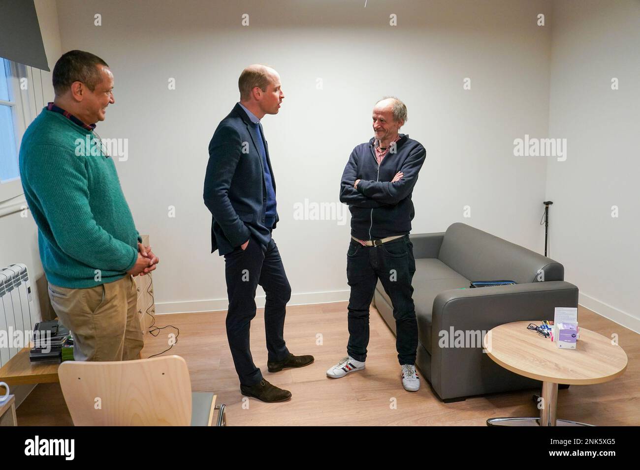 The Prince of Wales (centre) speaks with resident Mark Chiverton (right ...