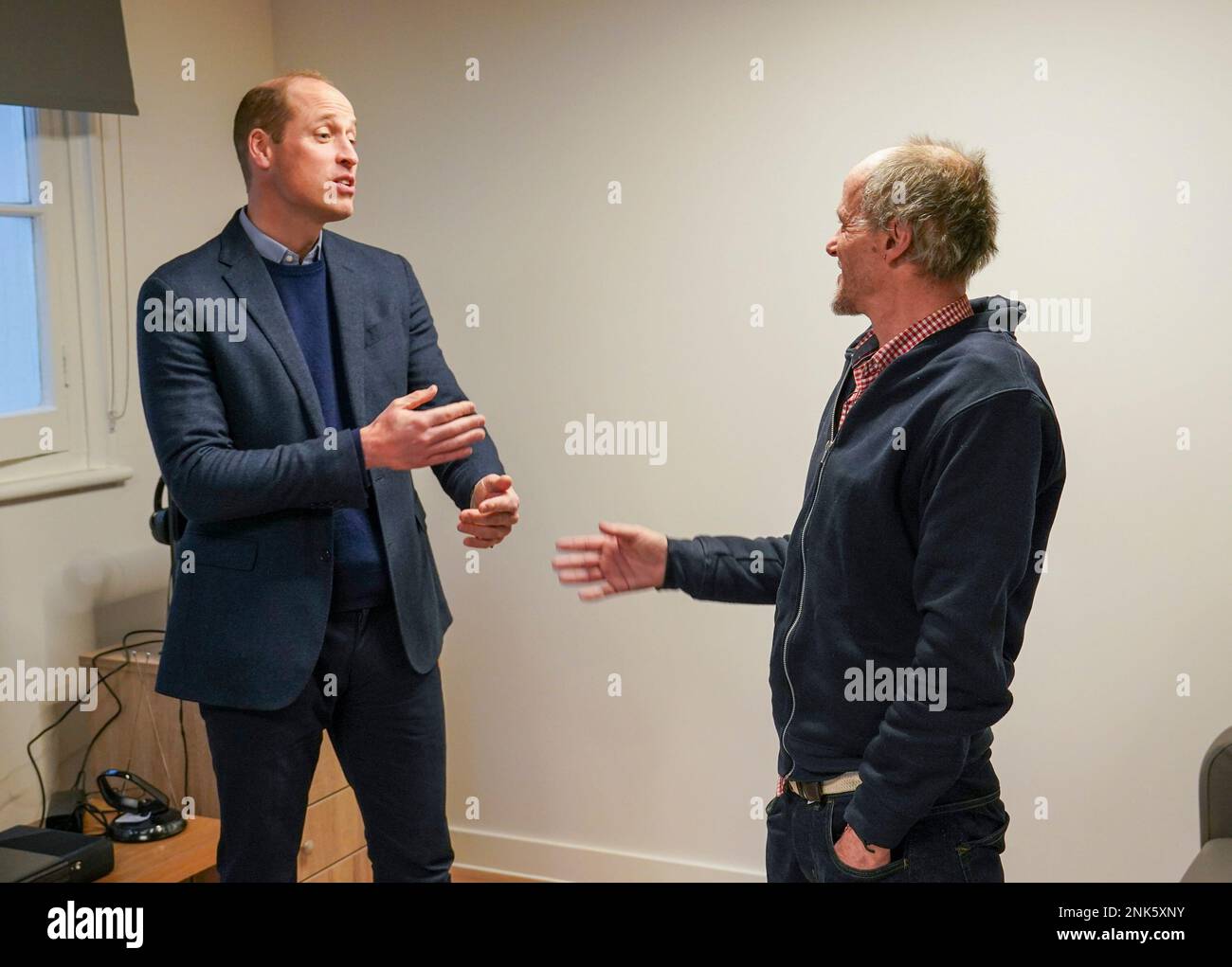 The Prince of Wales (left) speaks with resident Mark Chiverton, during ...