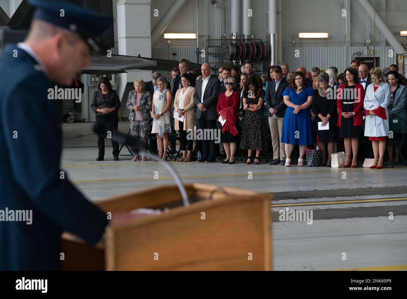 Attendees bow their heads during an invocation during the 11th Air ...