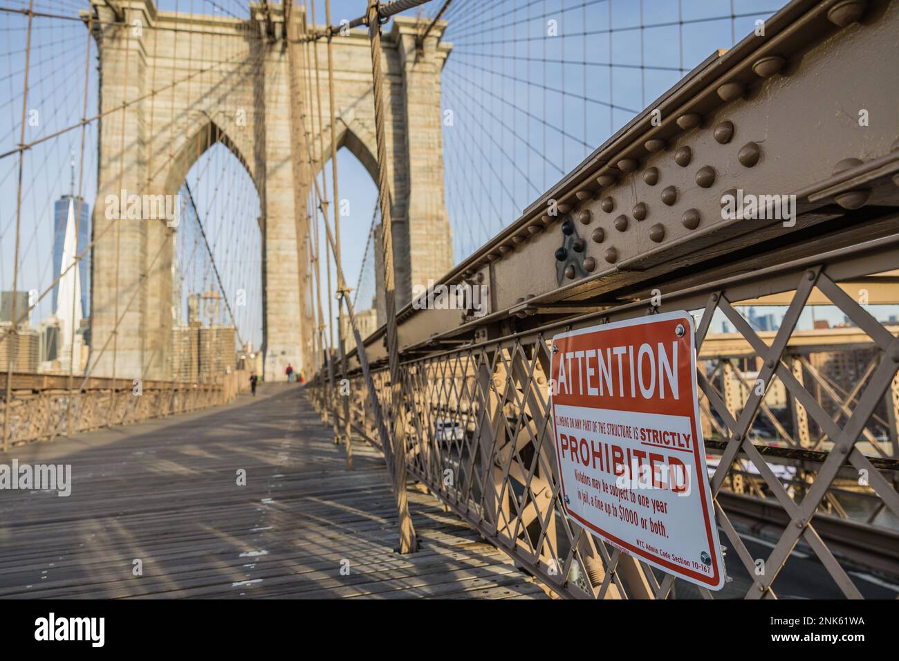 Signs with a warning against climbing the structures of the Brooklyn ...
