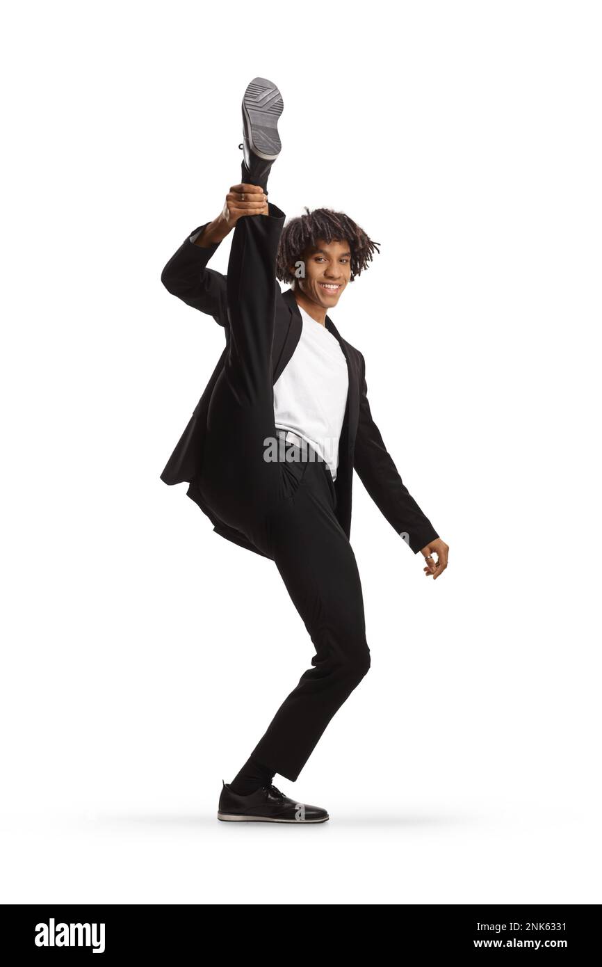 African american man in a suit dancing and lifting leg up isolated on ...