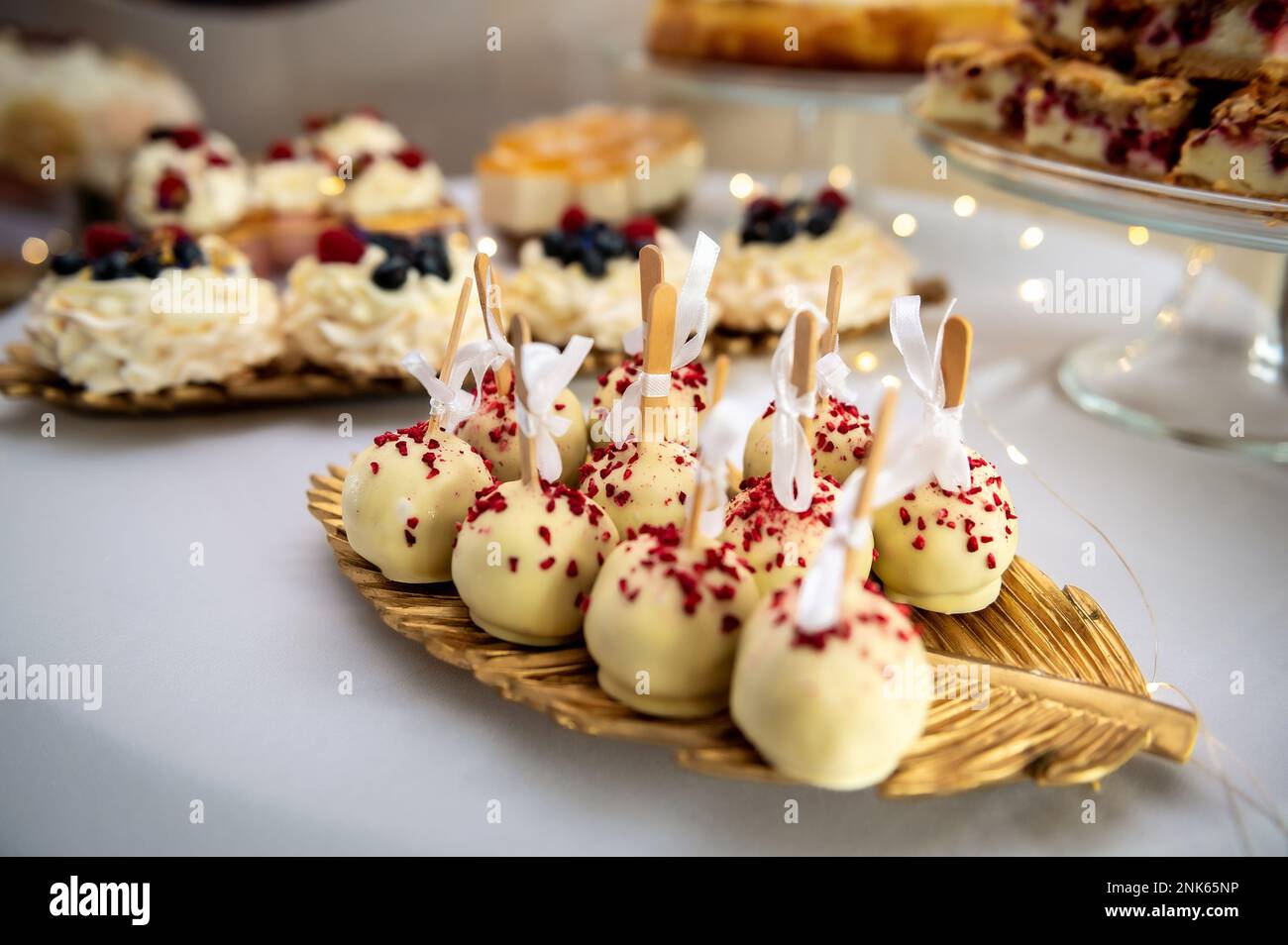 sweets, cake and cookies sweet balls on a stick in white chocolate with ...