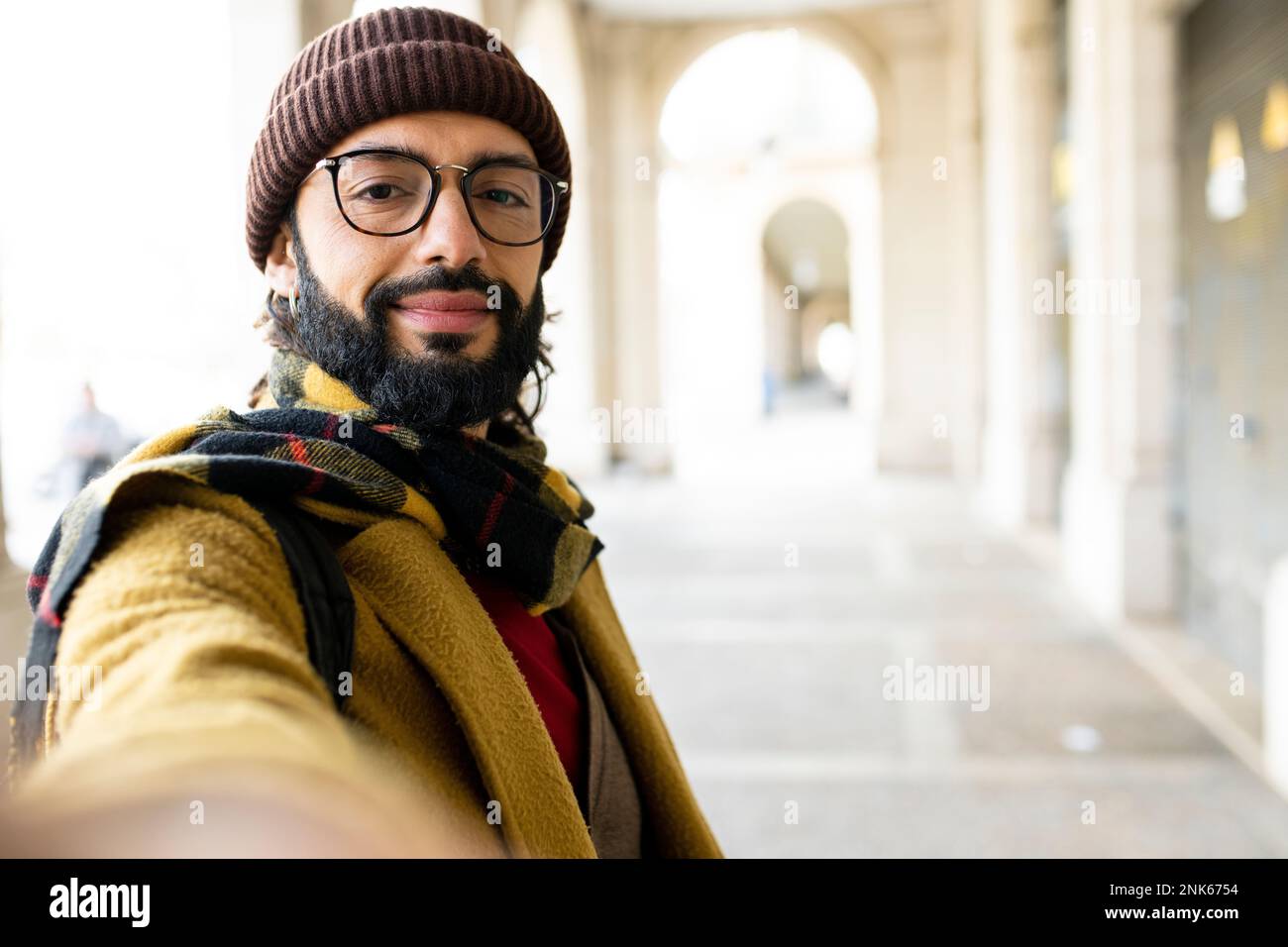 Happy man taking selfie walking on city street - Male tourist having ...