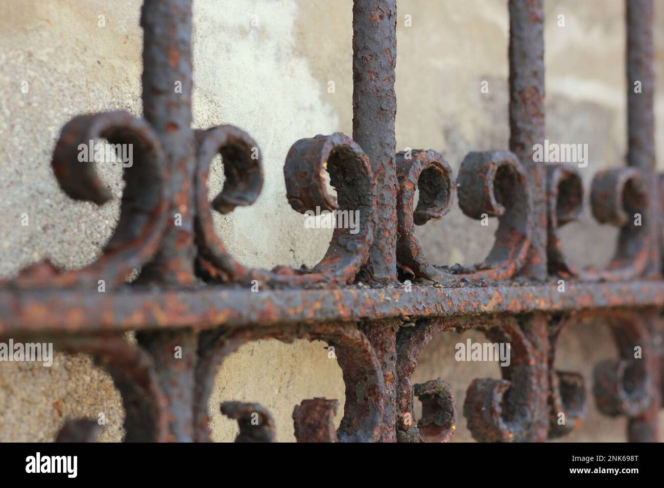 Rusted curly medieval metal gate decorations Stock Photo - Alamy