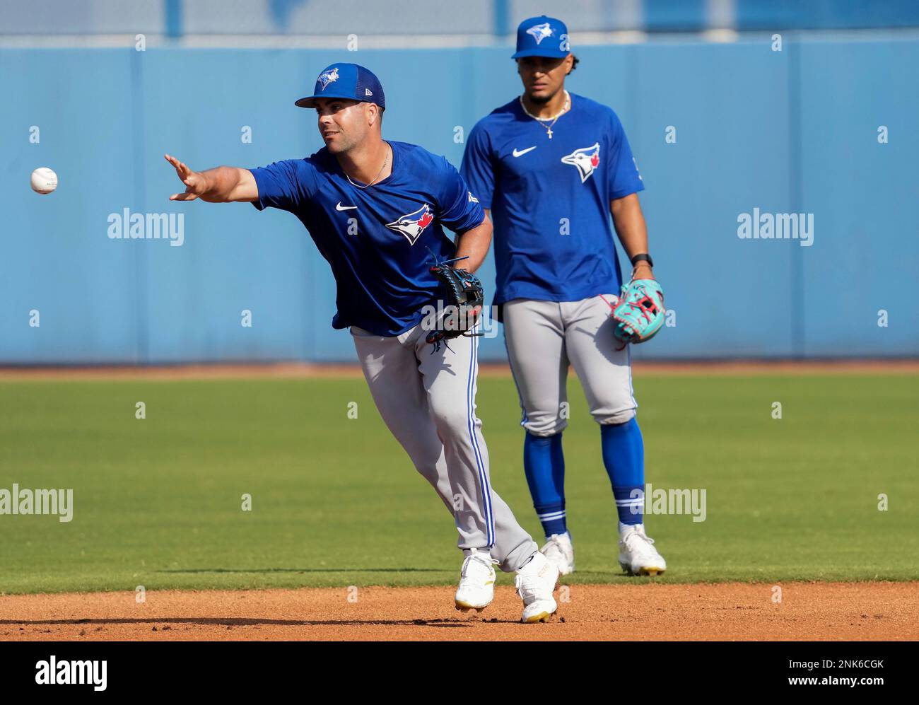 Toronto Blue Jays second baseman Whit Merrifield, left, tosses the ball ...