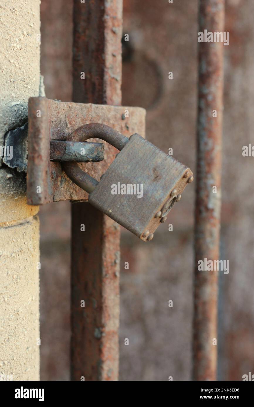 Vintage traditional metal padlock keeping a gate closed Stock Photo - Alamy