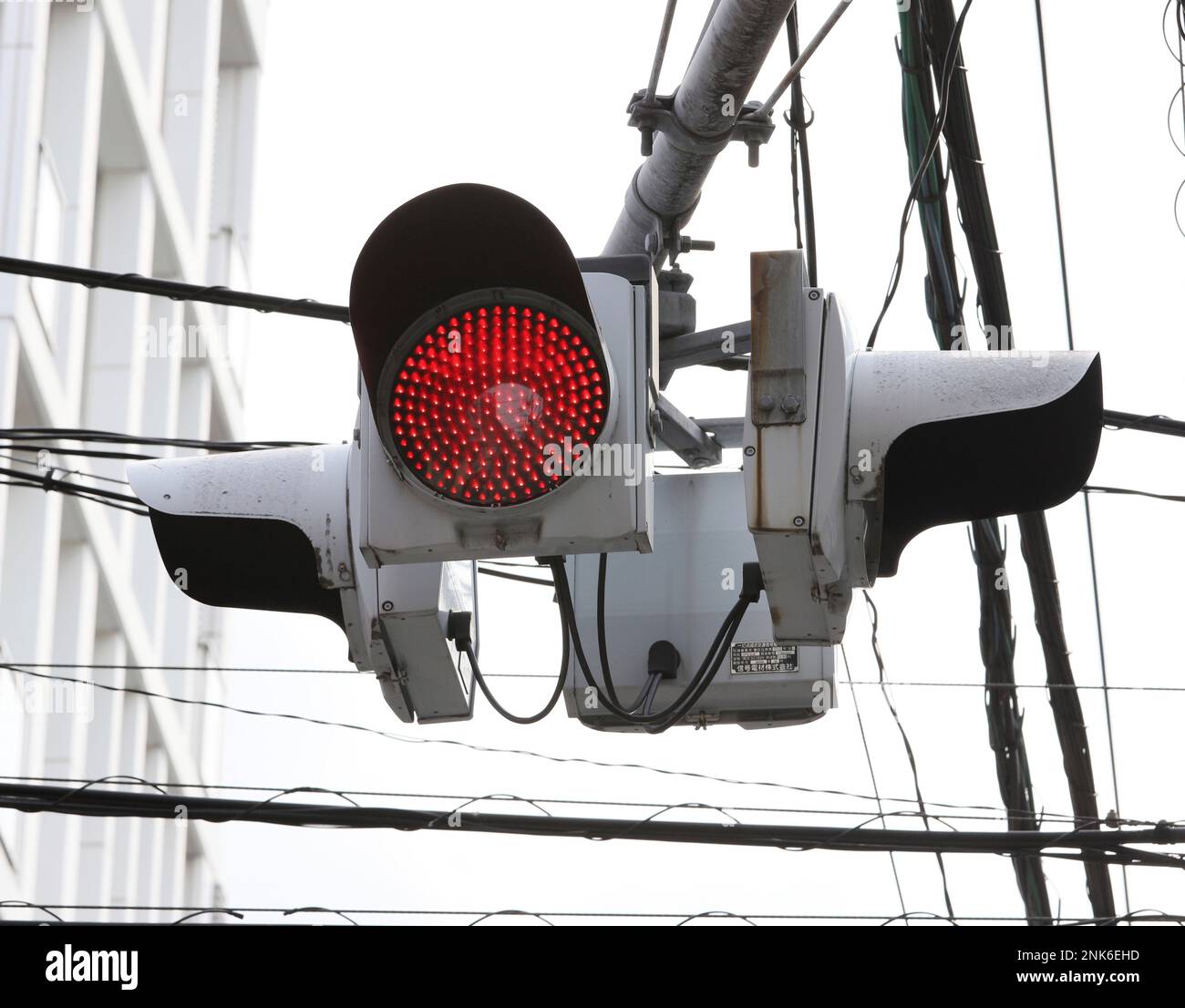 The red light of one light single traffic signal is flashing at ...