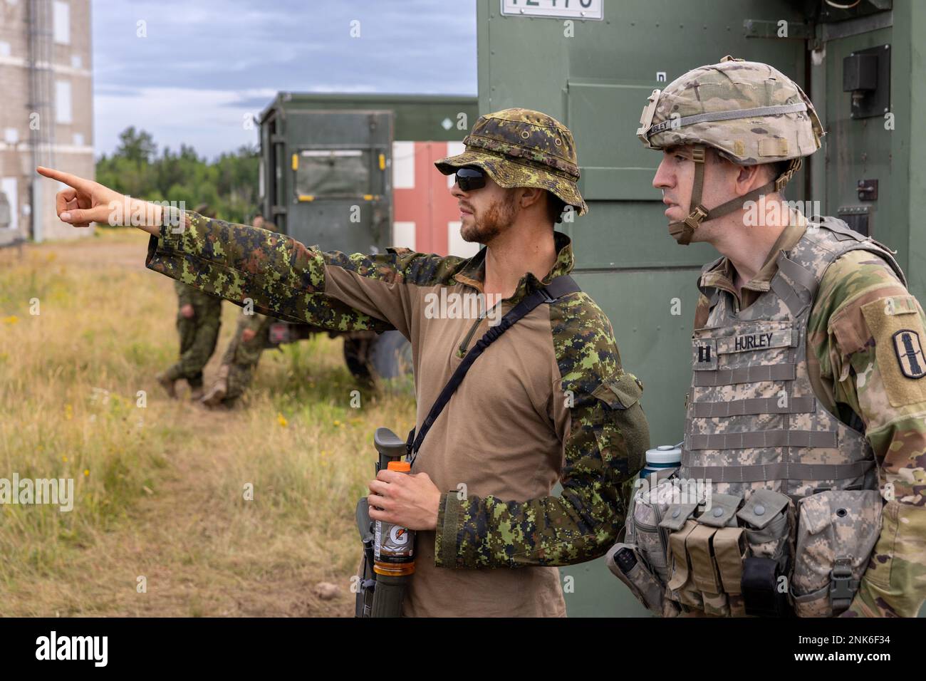 A Canadian artillery officer candidate discusses tactics with an ...