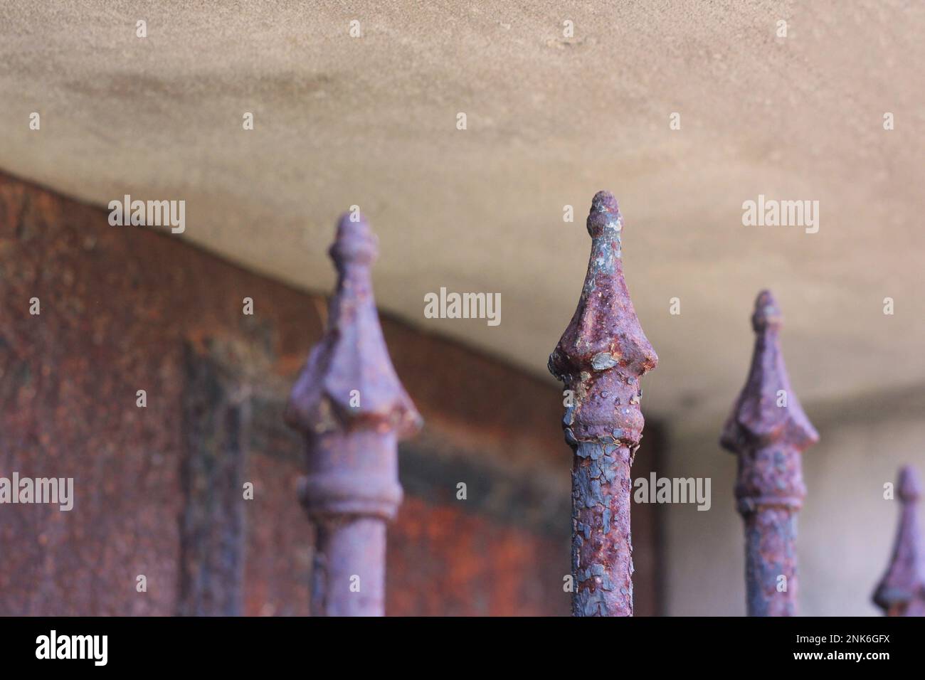 Vintage traditional rusty metal fence with sharp points as a protection ...