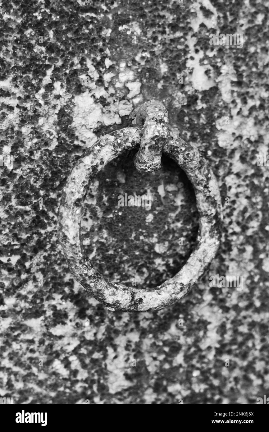 Medieval loop door handle with lots of iron and rust in a black and ...