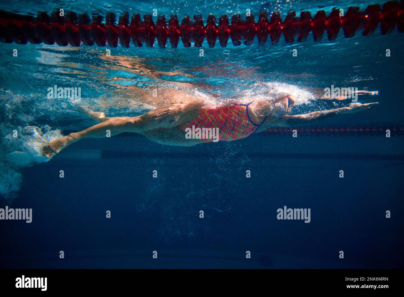 Coordinated movements, speed. Professional female swimmer training in ...