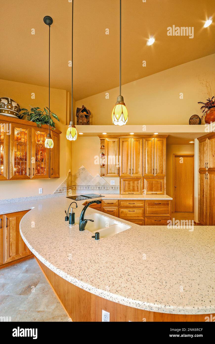 Views of a semi-circular countertop and wood cabinets in this ...