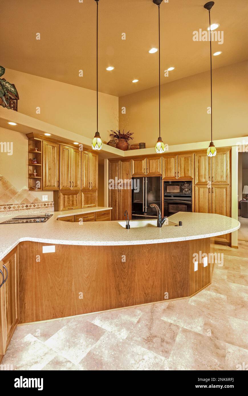 Views of a semi-circular countertop and wood cabinets in this ...