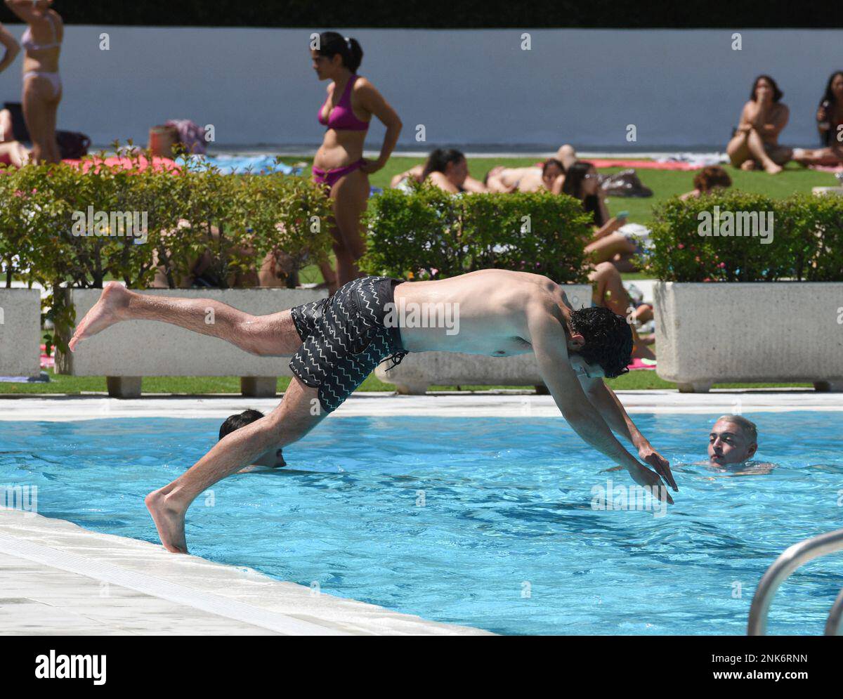 Several people bathe and sunbathe at the municipal swimming pool in ...
