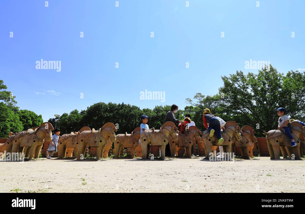 Around 190 haniwa (clay figures) of houses, people and animals line up ...