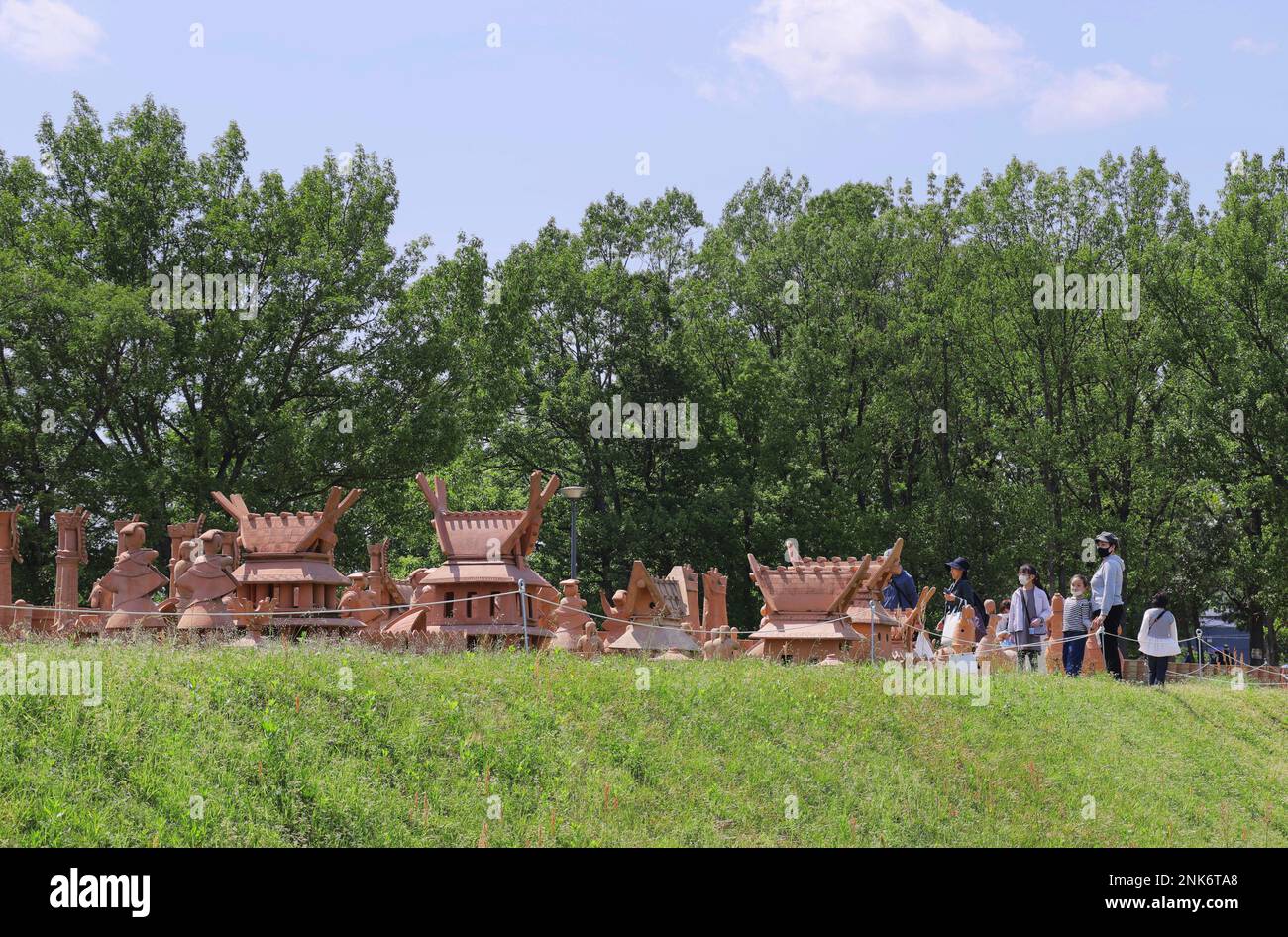 Around 190 haniwa (clay figures) of houses, people and animals line up ...
