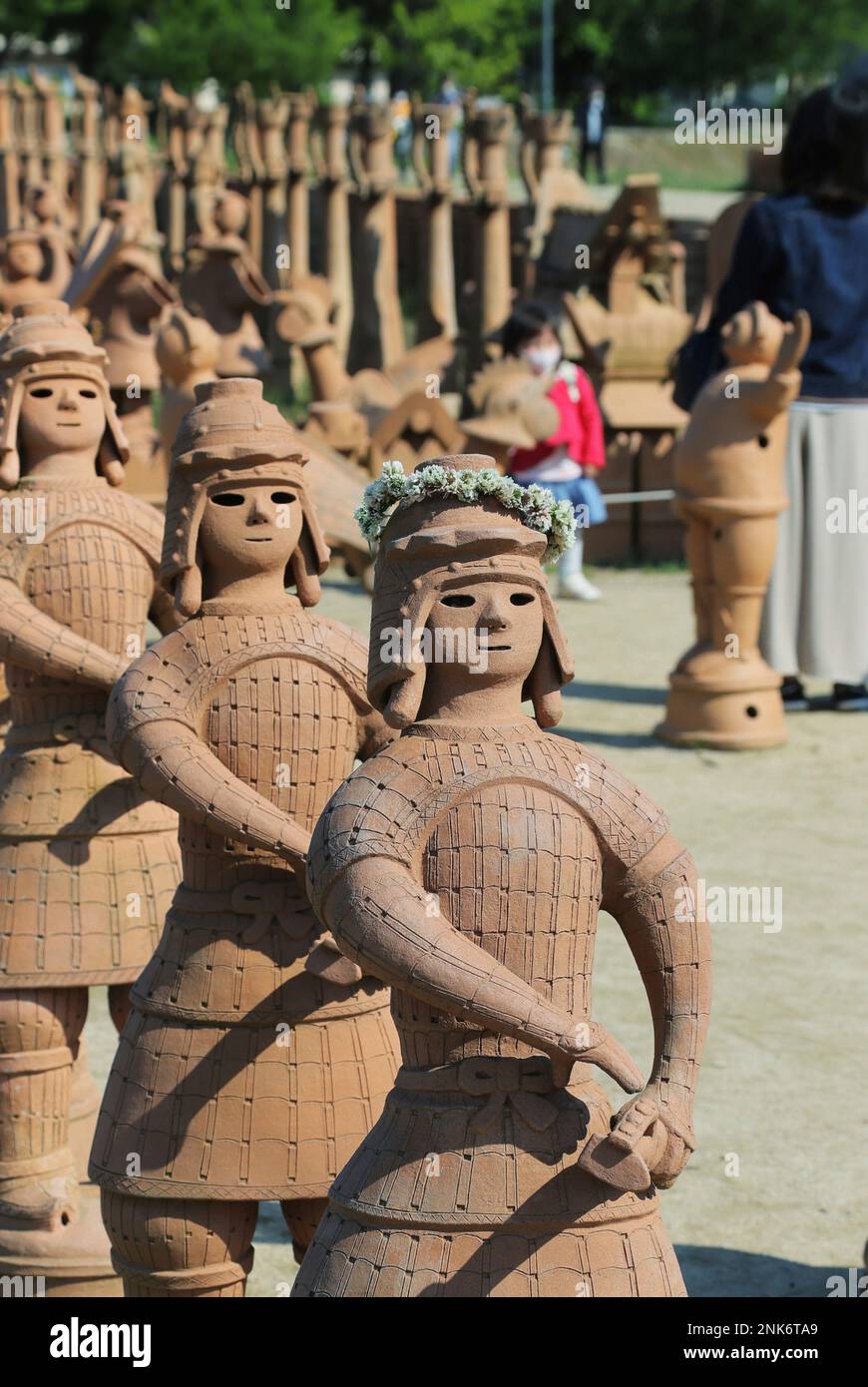 Around 190 haniwa (clay figures) of houses, people and animals line up ...