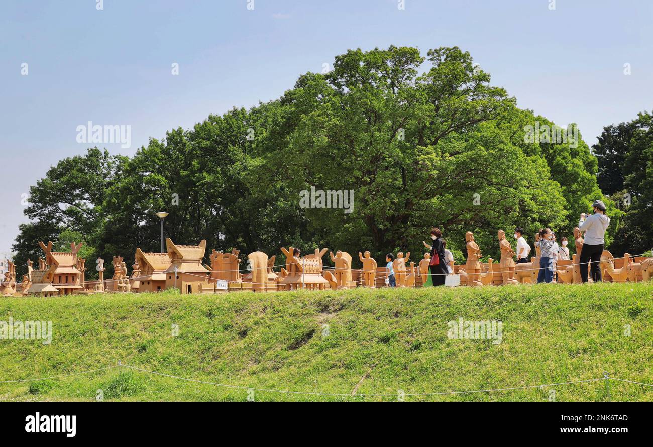 Around 190 haniwa (clay figures) of houses, people and animals line up ...